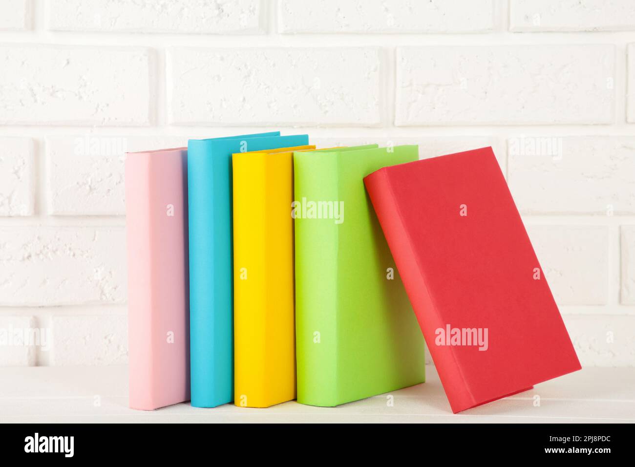 Multi coloured school books on a white background. Top view Stock Photo ...
