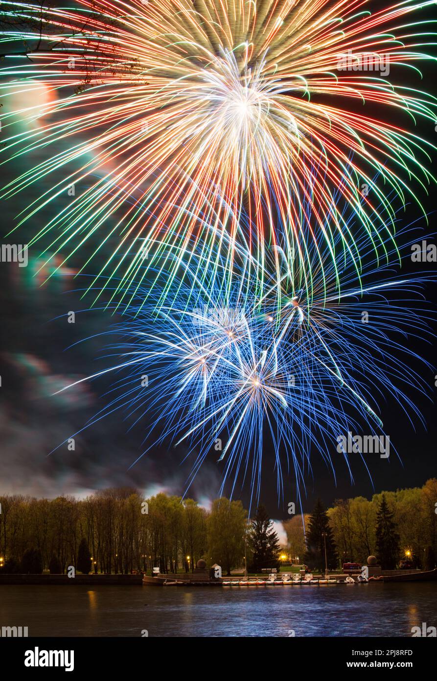 Bright multi-colored fireworks lights in the black night sky during the ...