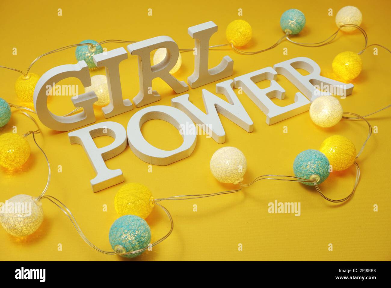 Girl Power alphabet letter with LED cotton balls on yellow background ...