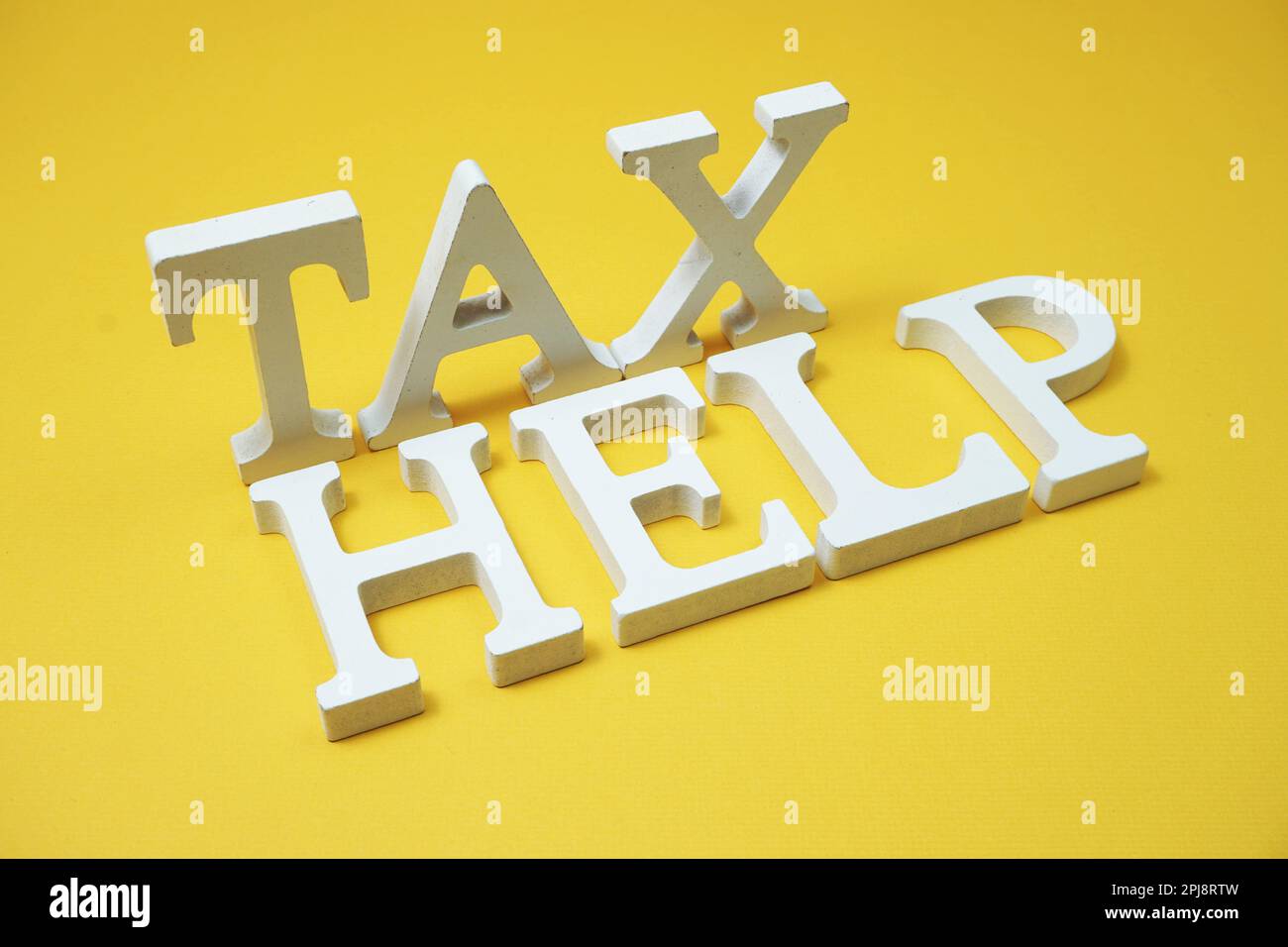 Tax Help alphabet letters on yellow background Stock Photo - Alamy