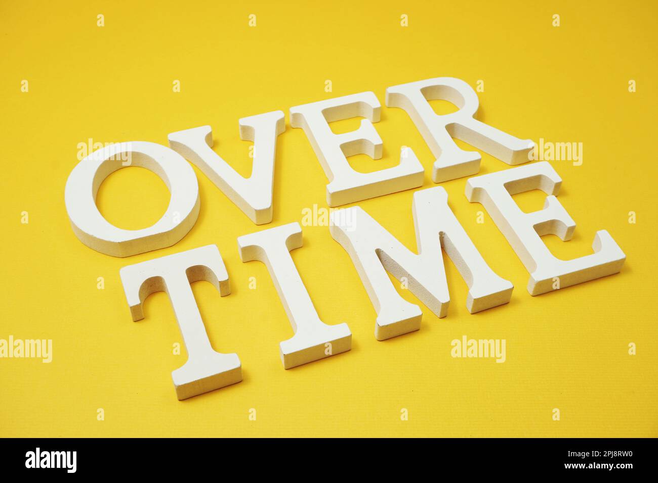 Over Time alphabet letters on yellow background Stock Photo - Alamy
