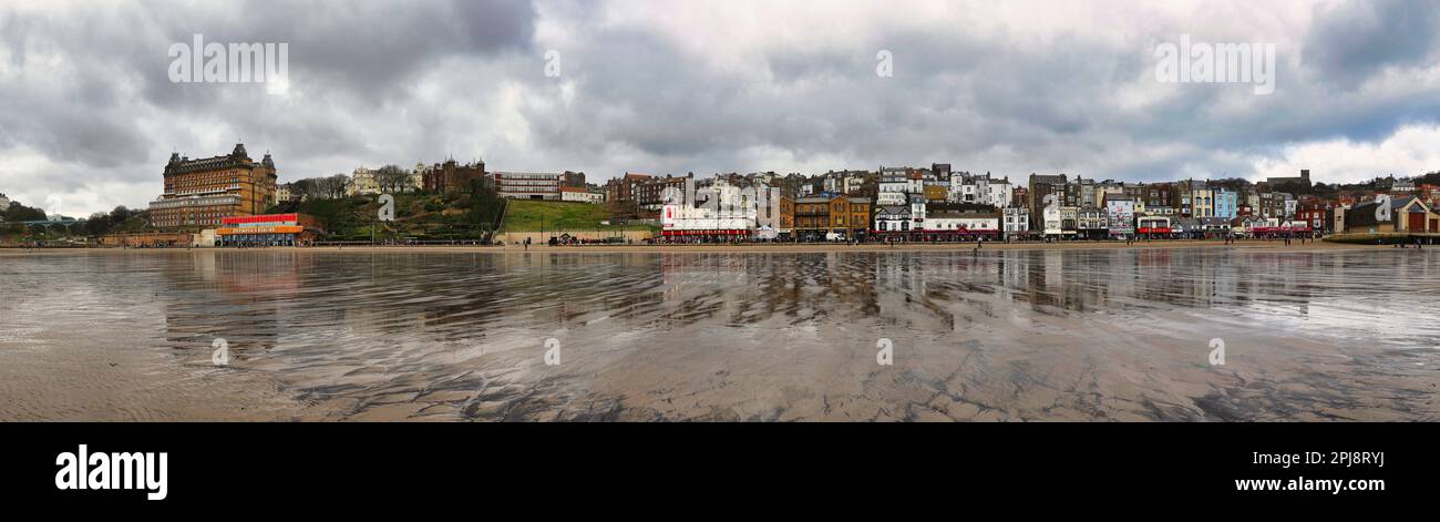 The tides out at Scarborough leaving a wet sheen on the beach Stock ...