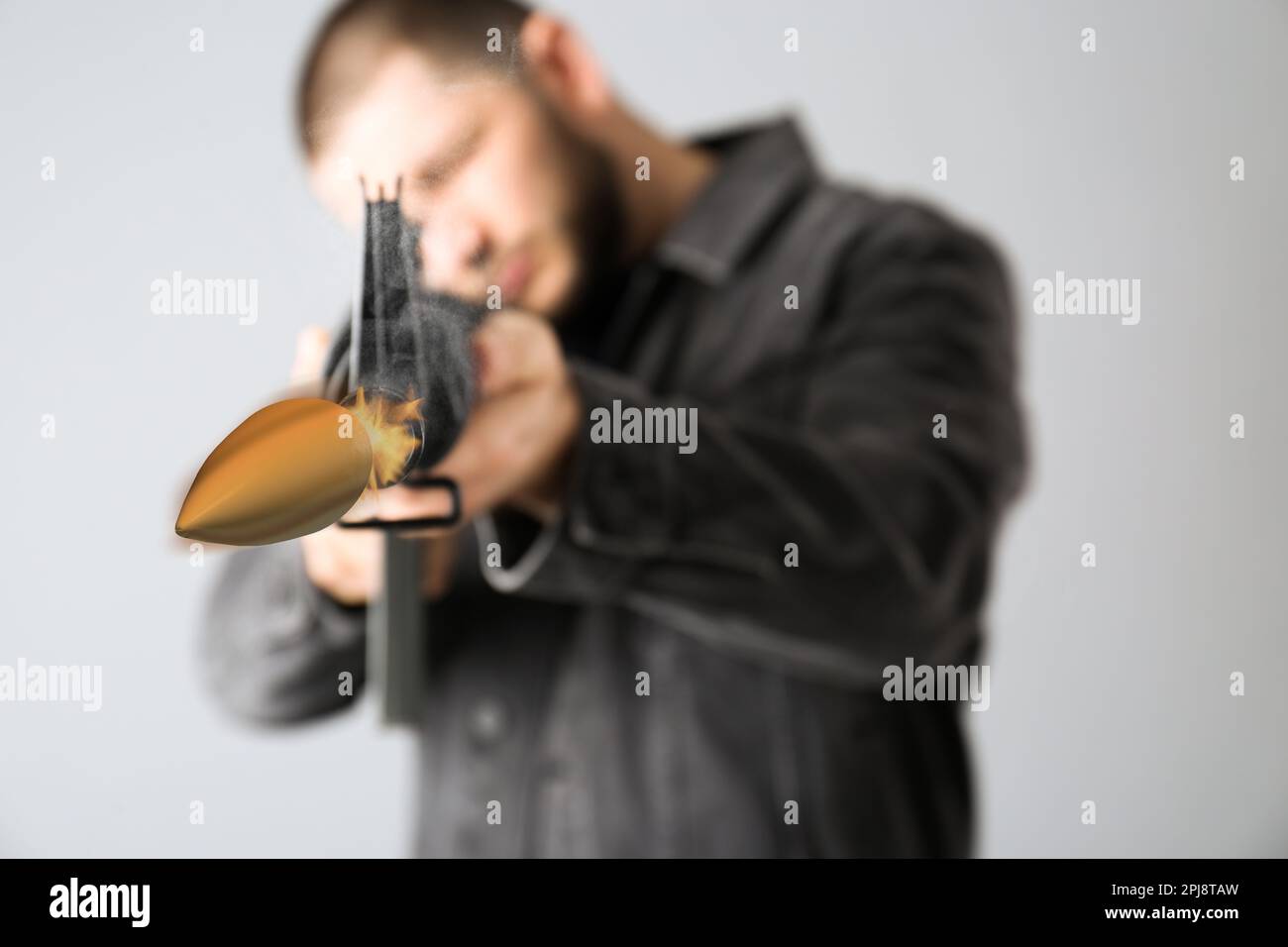 Man shooting from assault rifle on light background, focus on weapon ...
