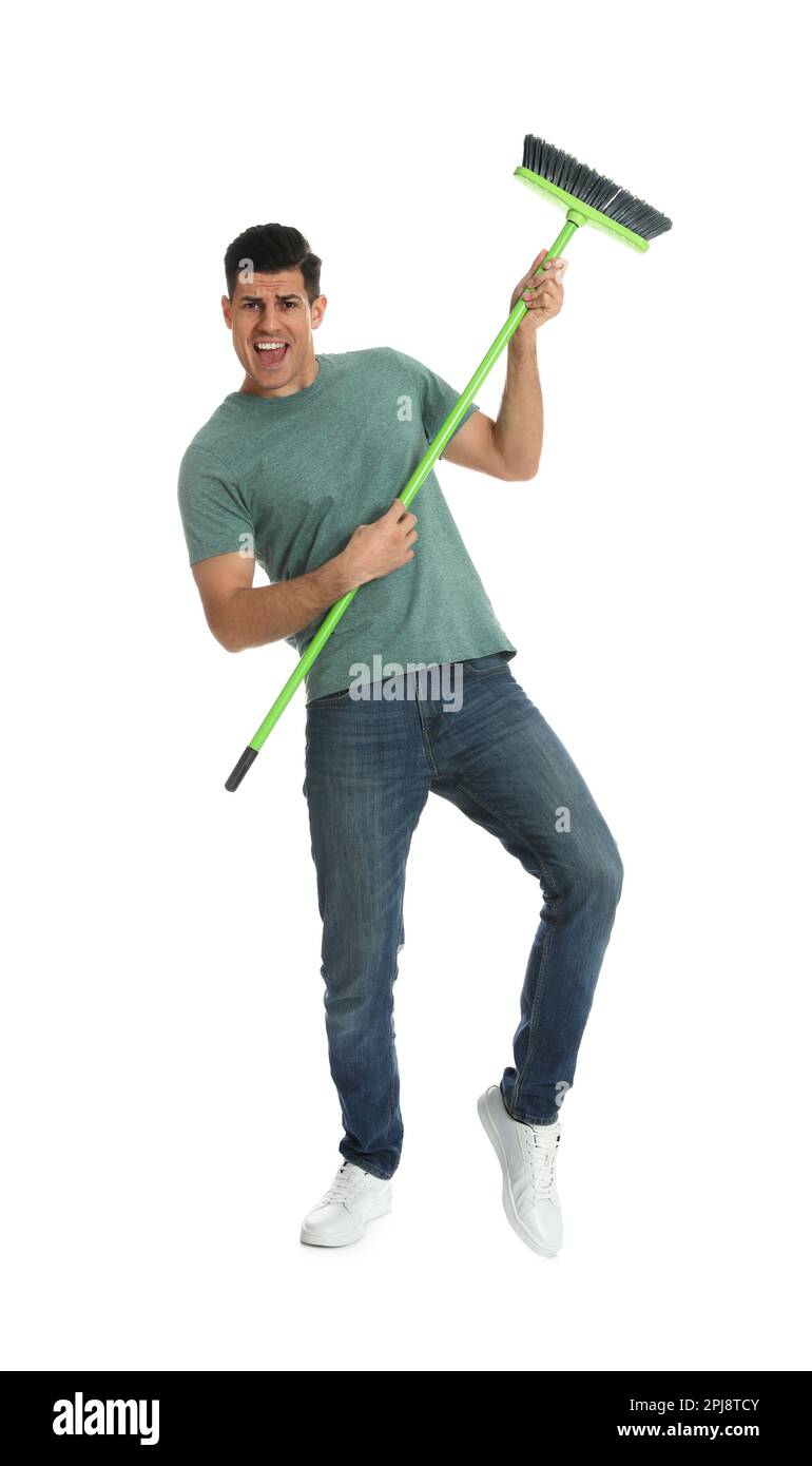 Man with green broom on white background Stock Photo - Alamy