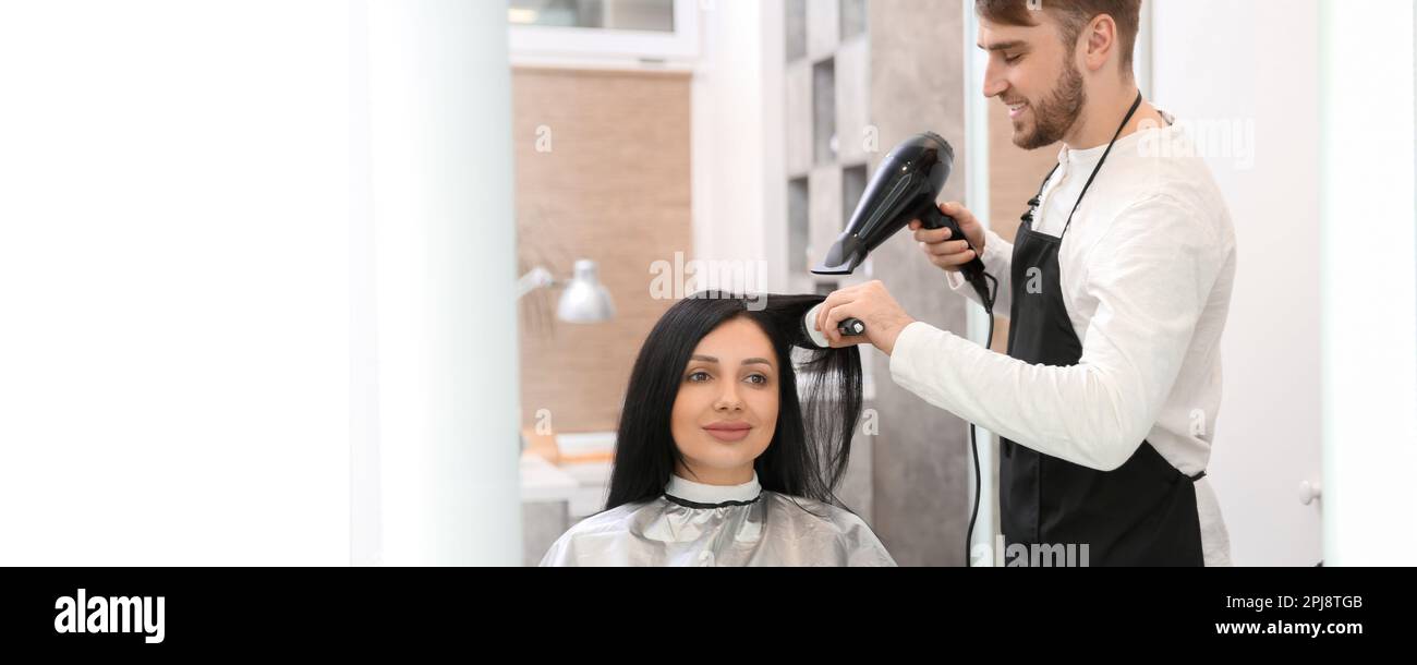 Professional male hairdresser working with client in salon. Banner ...