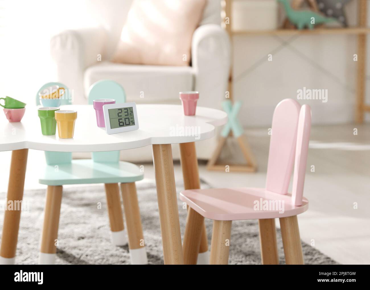 Digital hygrometer with thermometer on small table in children's room ...