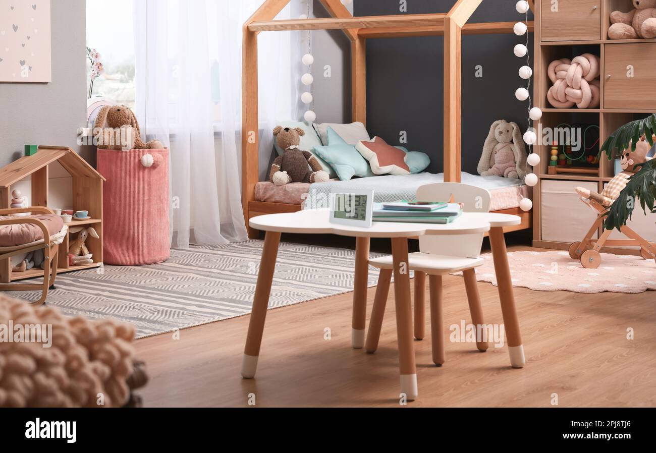 Digital hygrometer with thermometer on small table in children's room ...