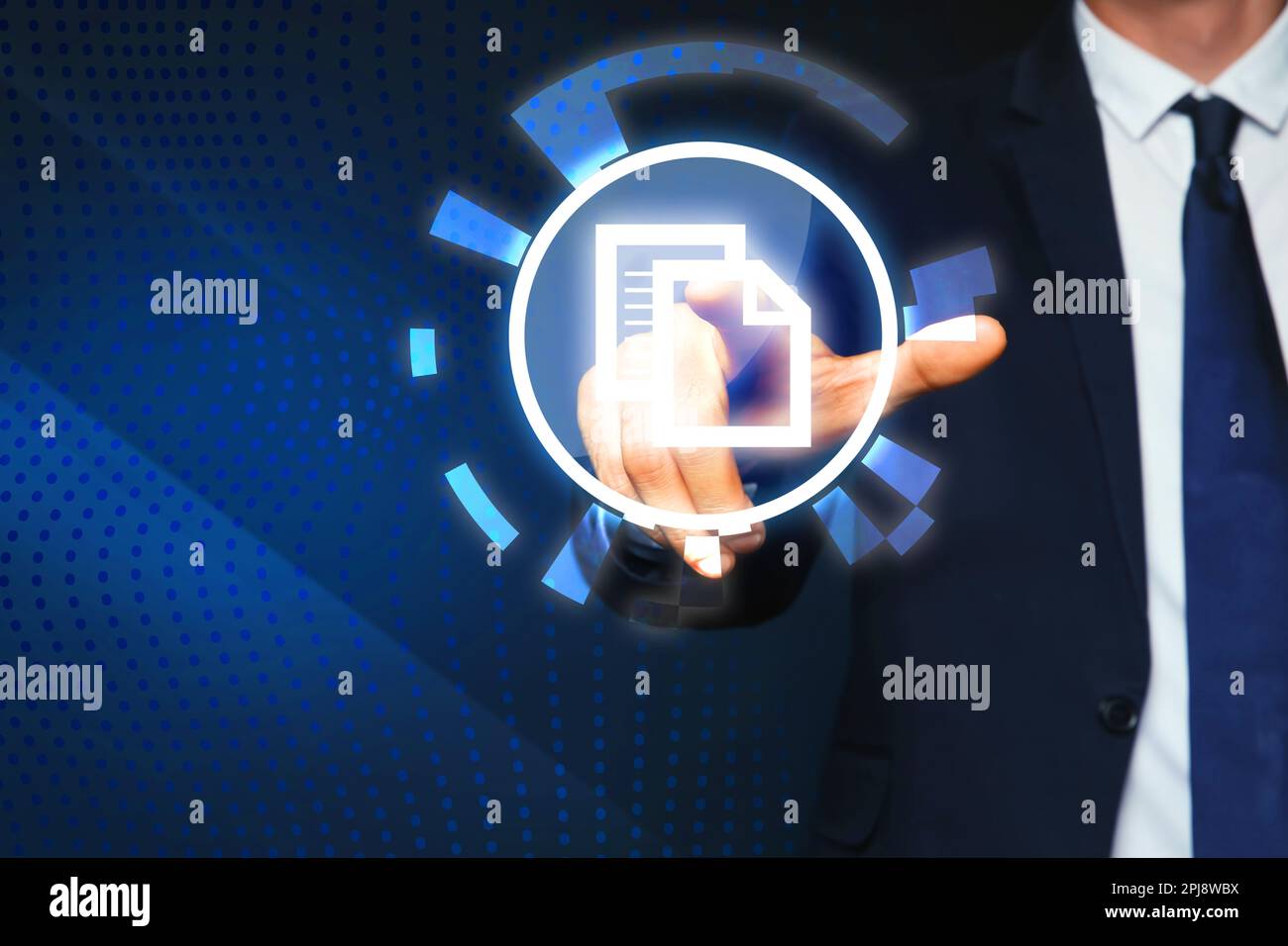 Man pointing at virtual icon of computer file on dark blue background ...