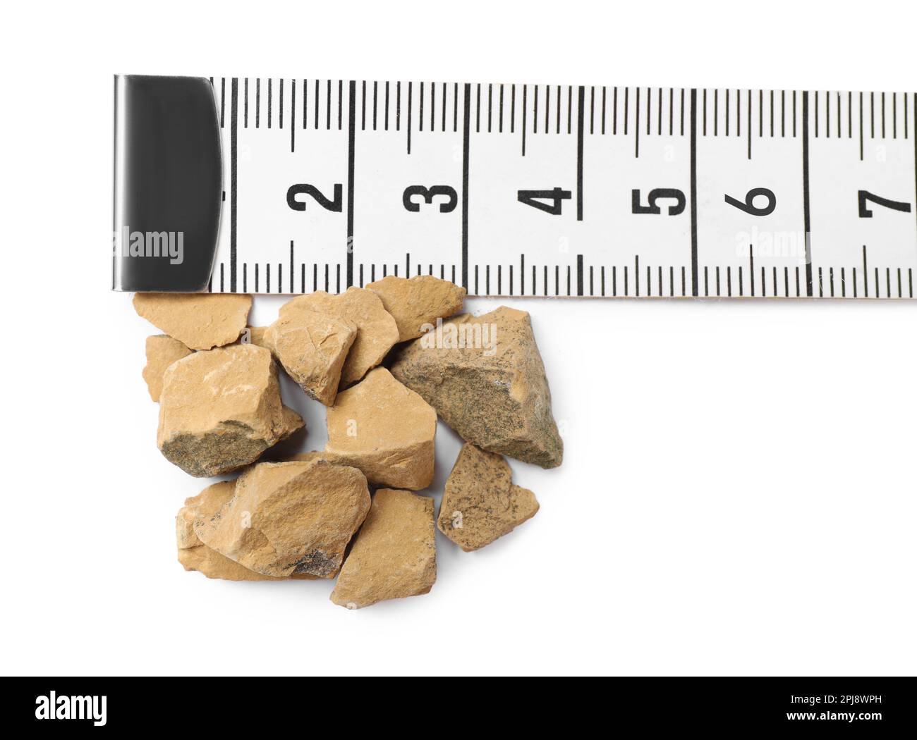 Pile of kidney stones and measuring tape on white background, top view ...