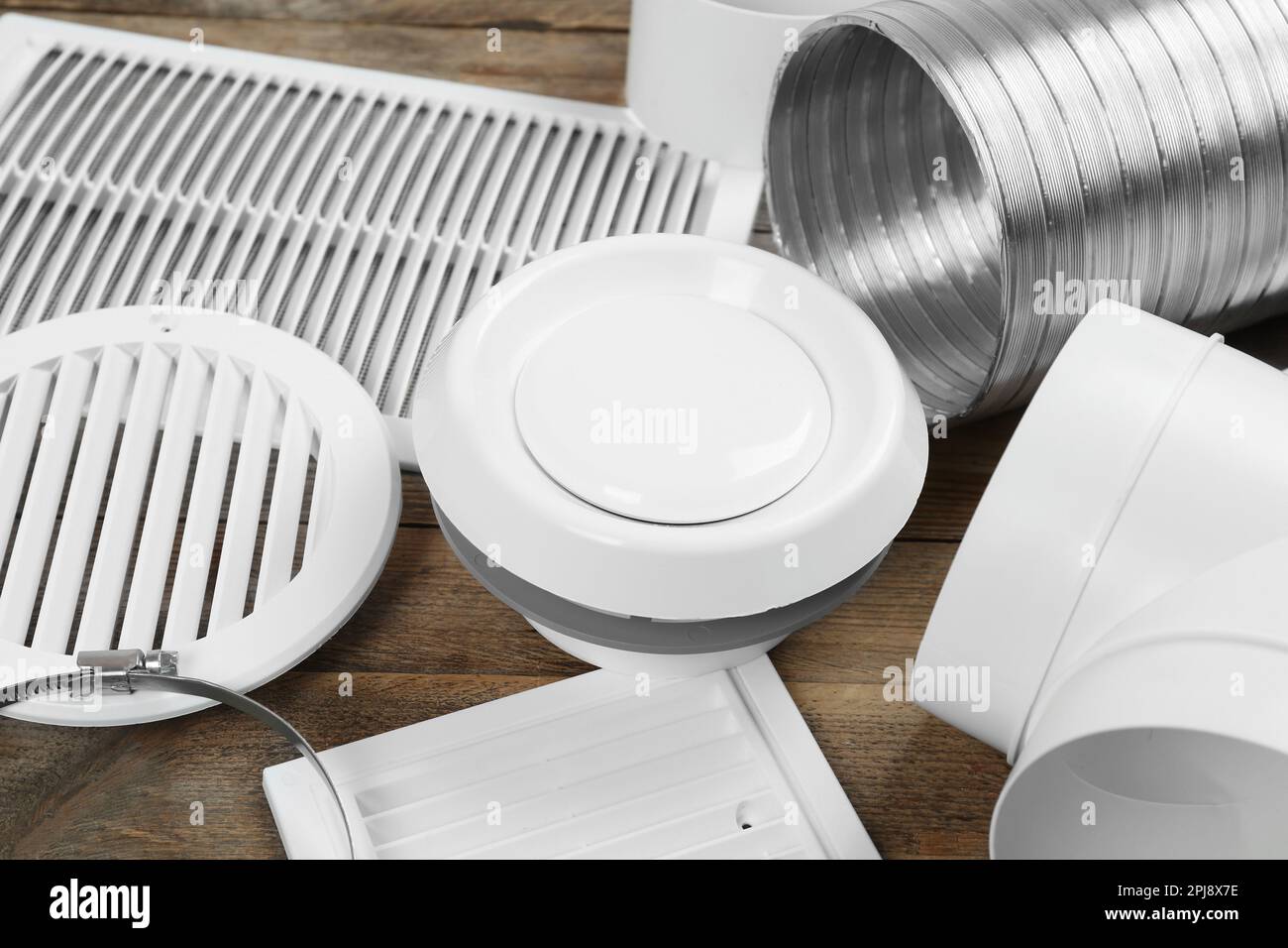 Parts of home ventilation system on wooden surface, closeup Stock Photo ...