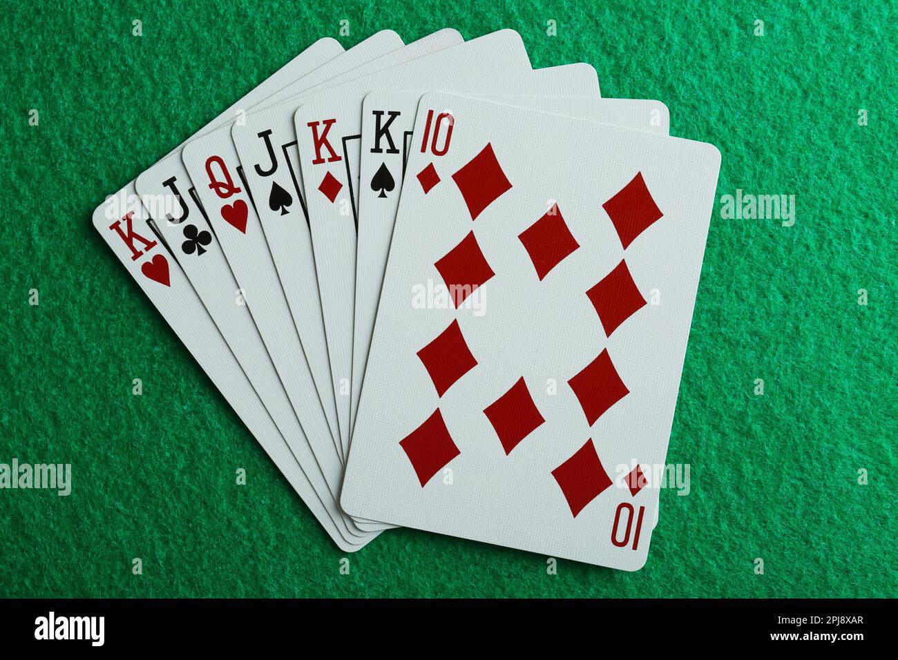 Playing cards on green table, top view Stock Photo - Alamy