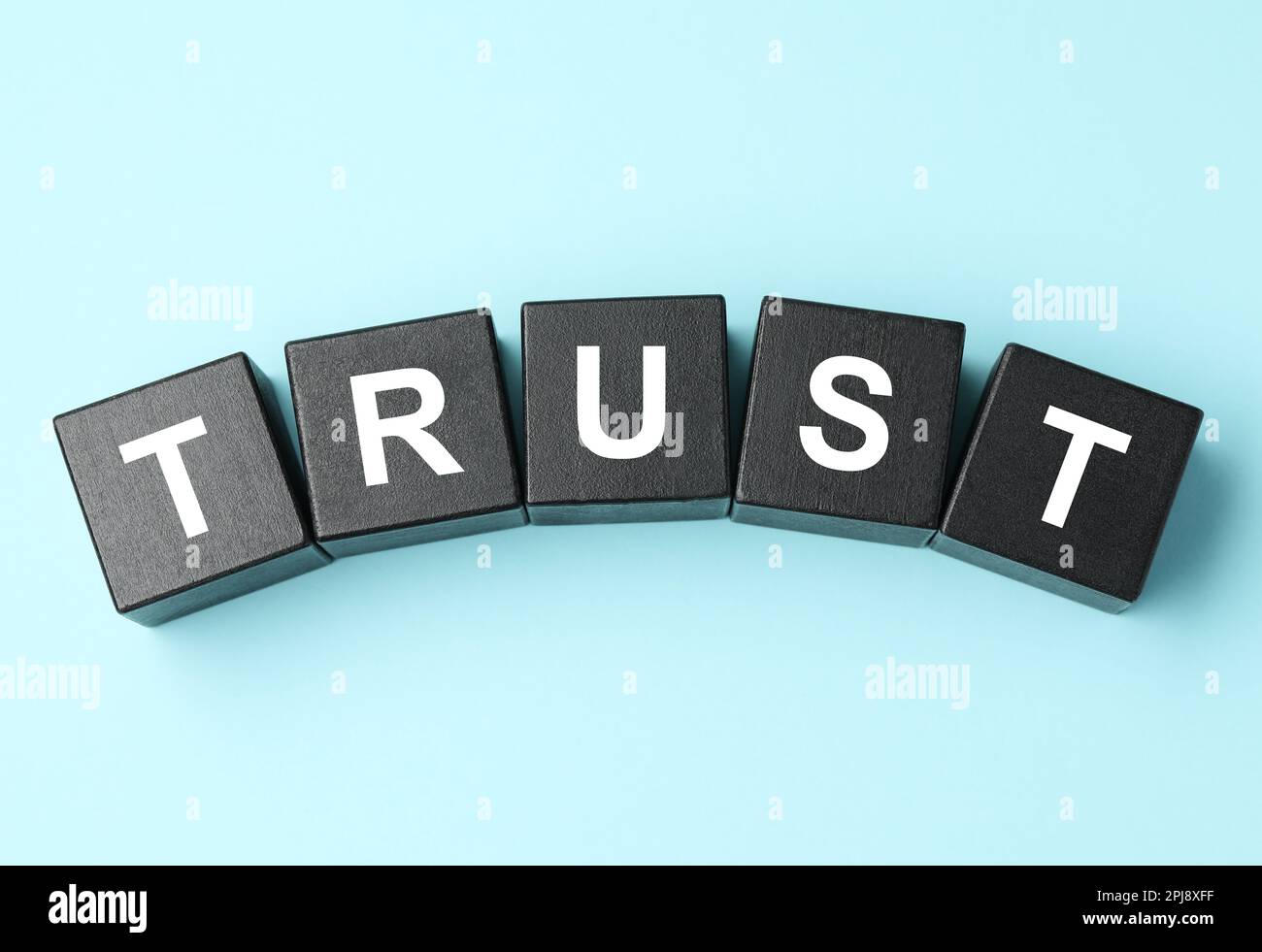 Word Trust made of black cubes on light blue background, flat lay Stock ...