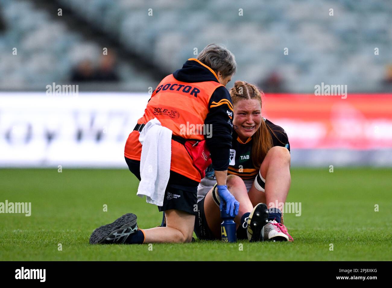 Edwina Munns-Cook of the Brumbies receives medical attention during the ...