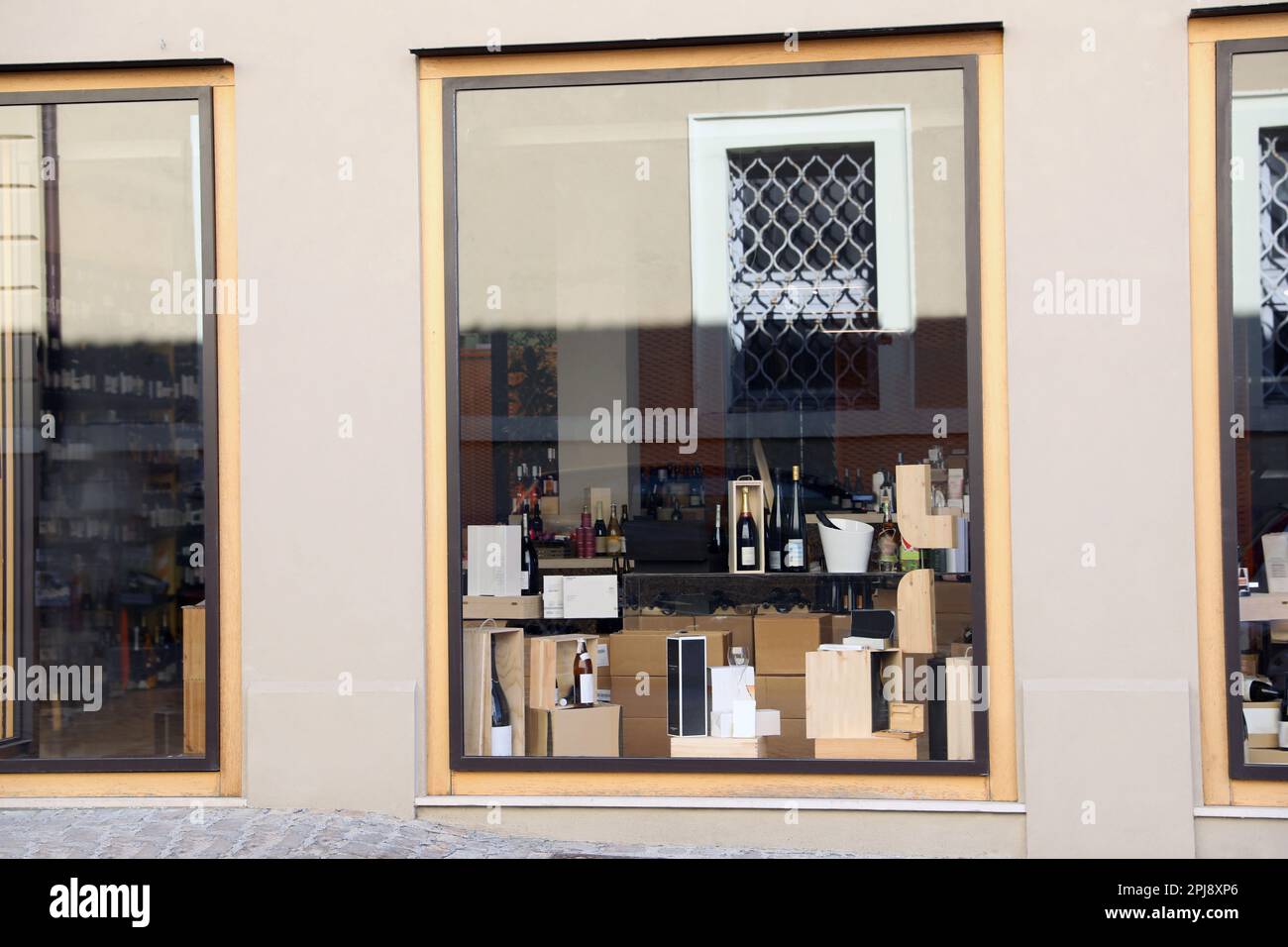 Bottles of different alcohol in wine shop, view through window Stock ...