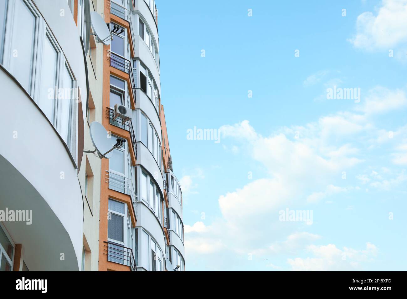 Exterior of multi-storey apartment building on cloudy day, low angle ...