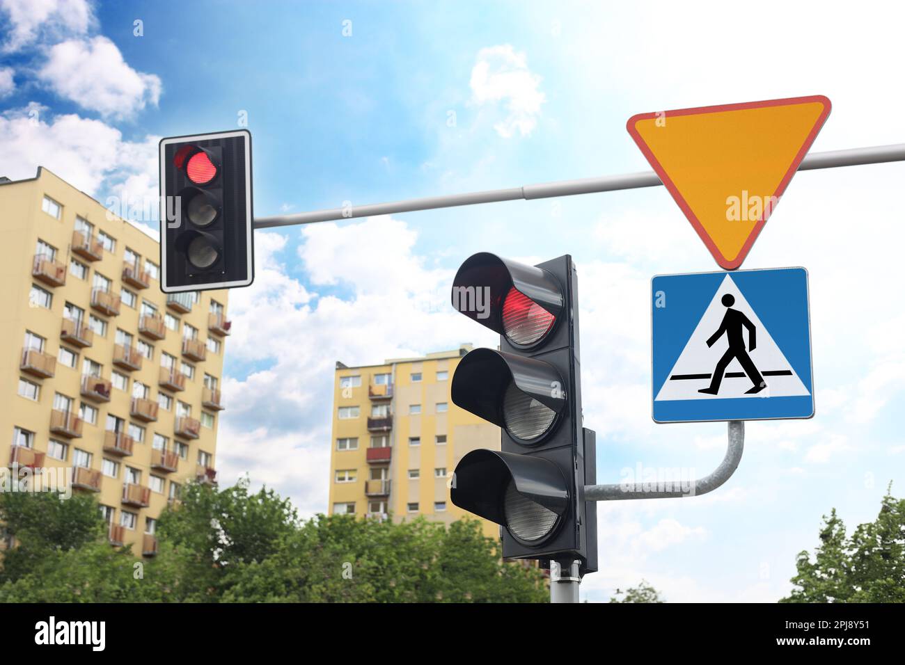 Different road signs and traffic lights on city street Stock Photo - Alamy