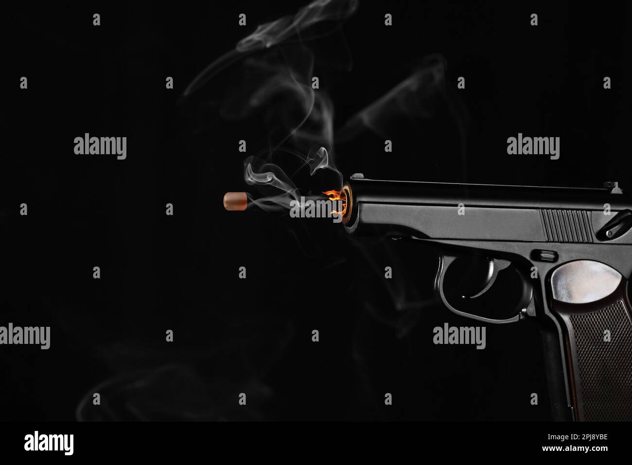 Bullet flying from gun on black background Stock Photo - Alamy
