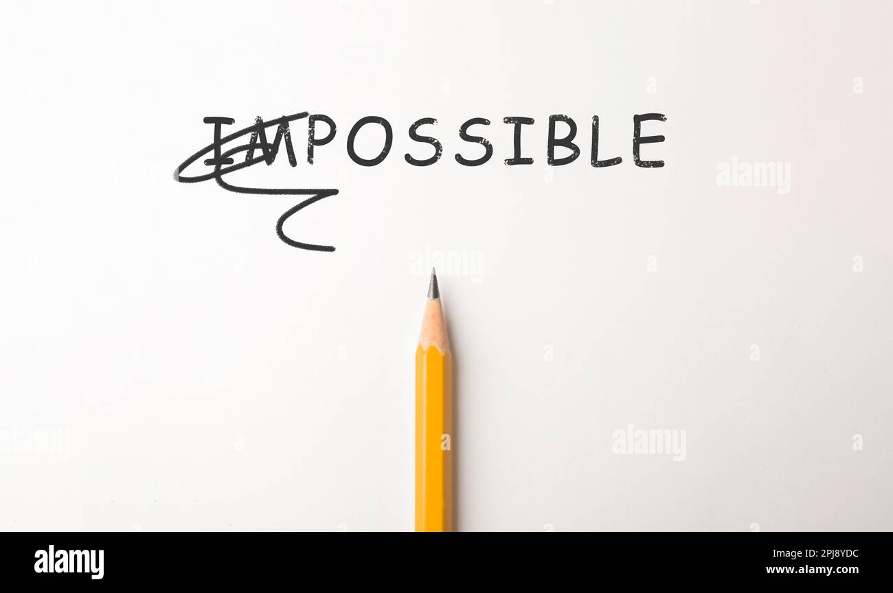 Word IMPOSSIBLE with crossed out letters IM and pencil on white ...