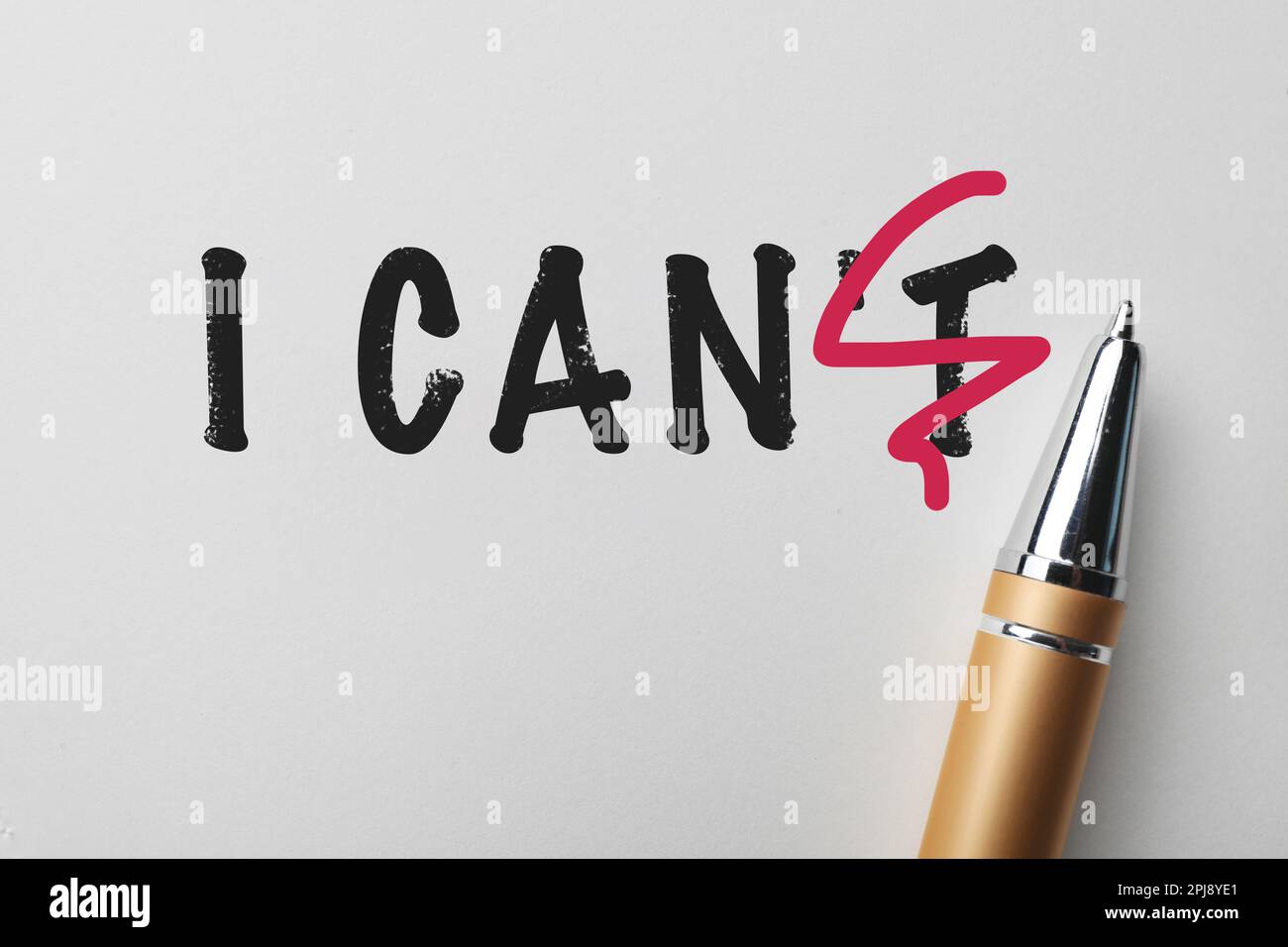 Phrase I CAN'T with crossed out letter T and pen on white background ...
