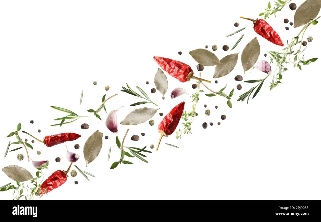 Many different spices flying on white background Stock Photo - Alamy