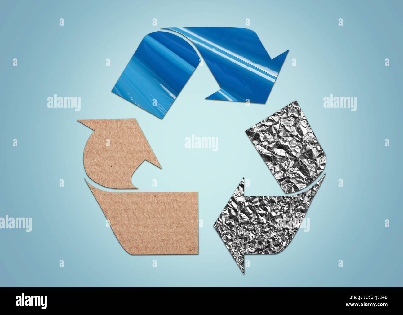 Recycling symbol made of crumpled foil, cardboard and turquoise stretch ...