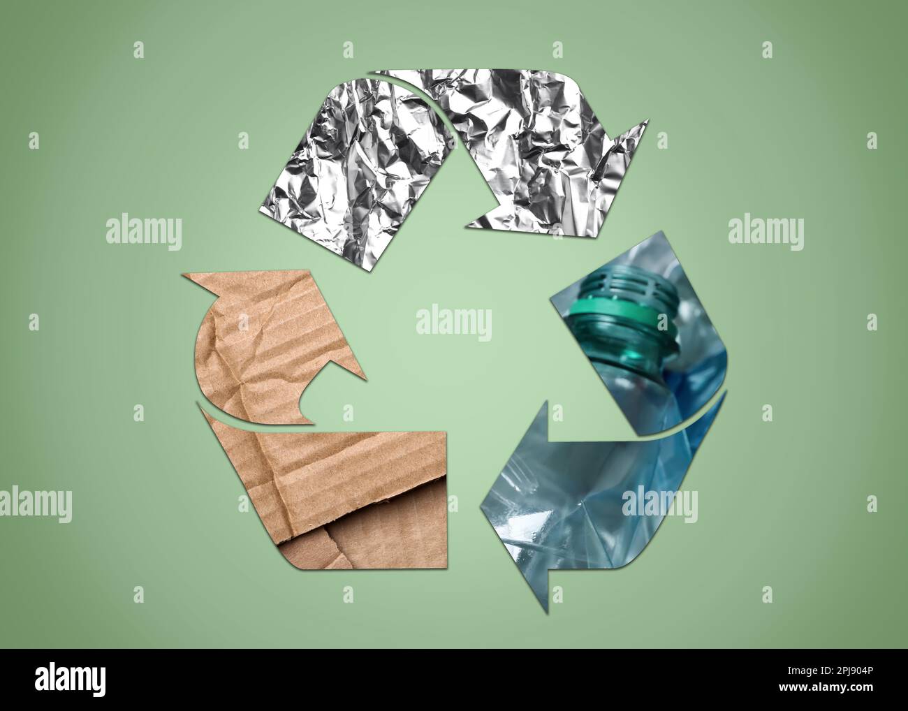 Recycling symbol made of crumpled foil, plastic bottles and cardboard ...