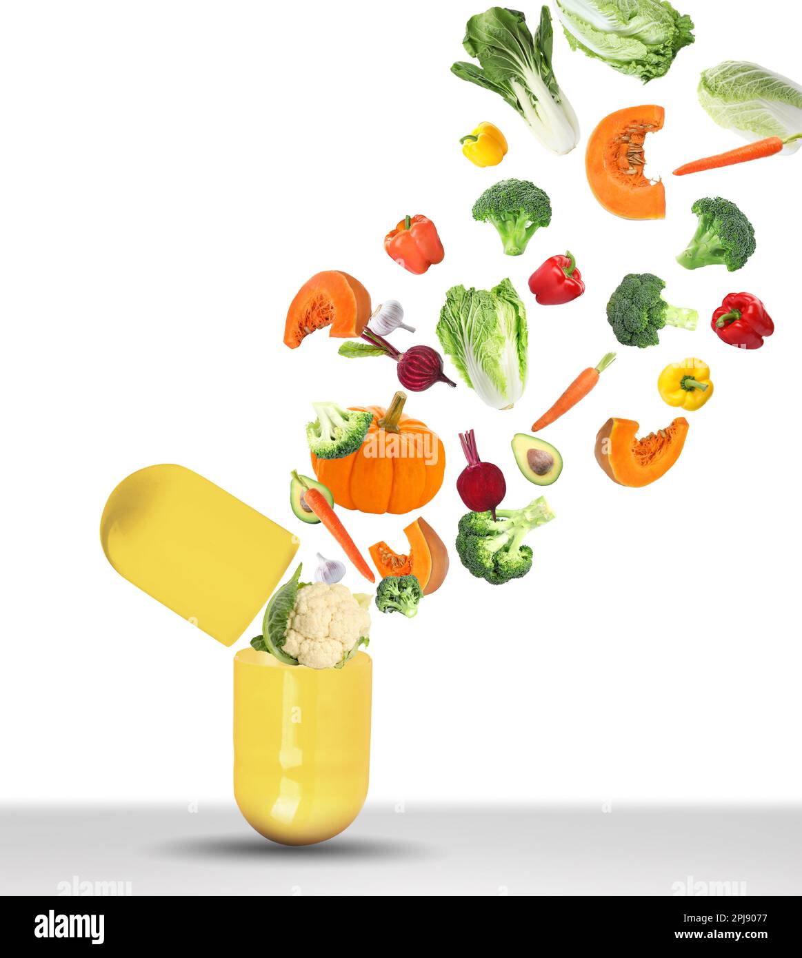 Dietary supplements. Capsule and different fresh vegetables flying on ...