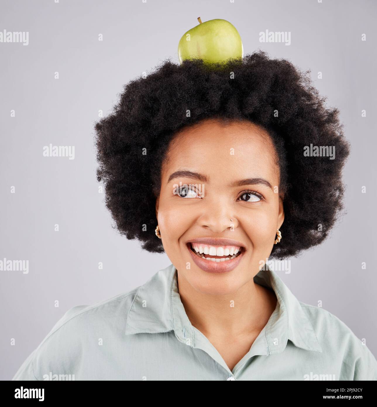 Thinking, apple on head and black woman with smile, health and ...