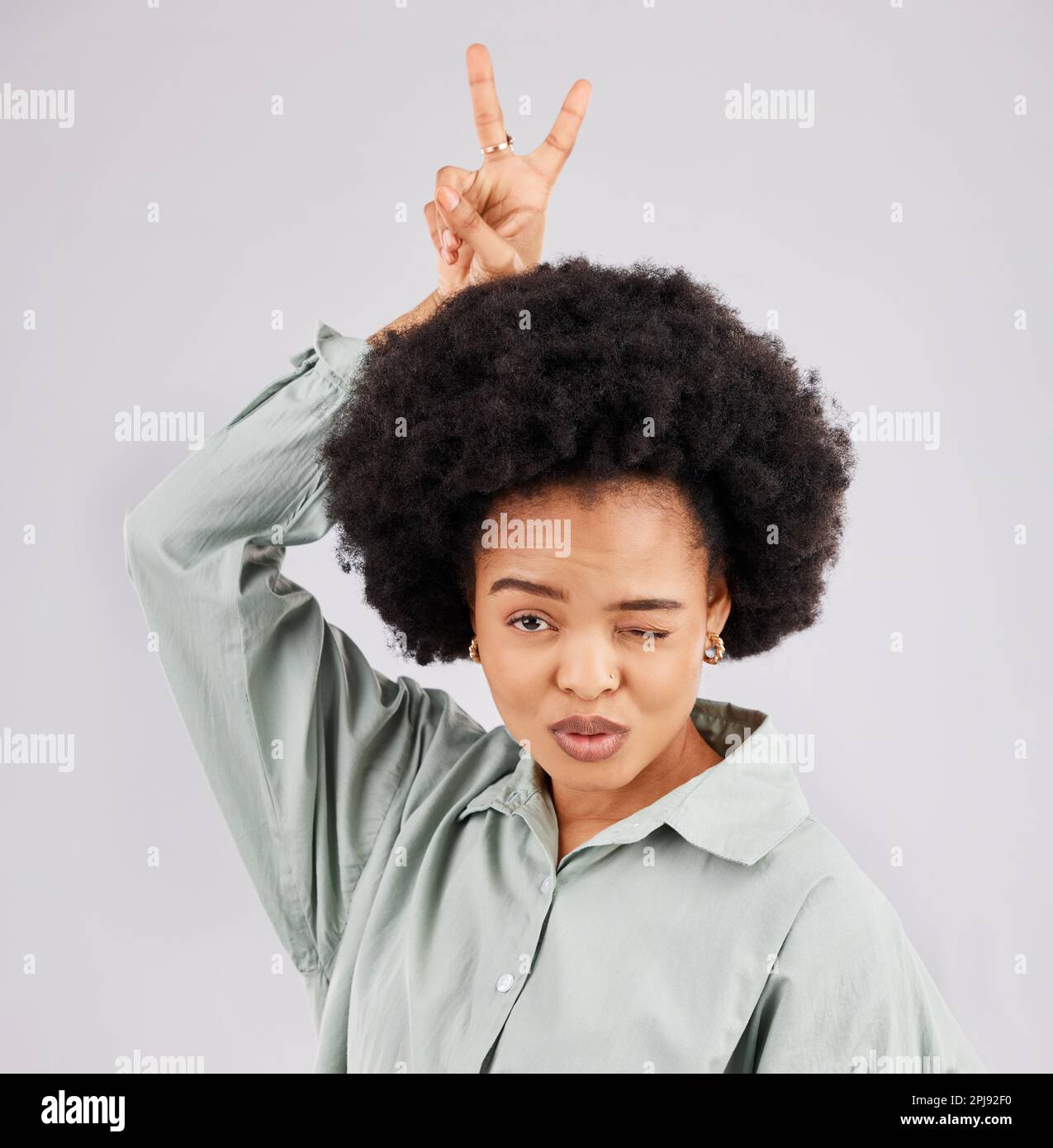 Goofy, happy woman and portrait with a wink, pout and bunny ears hand ...