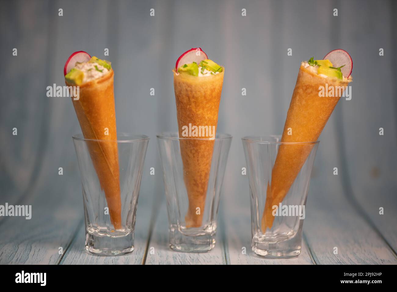Brick cone with tuna sauce, mayonnaise, avocado and radish slice Stock ...