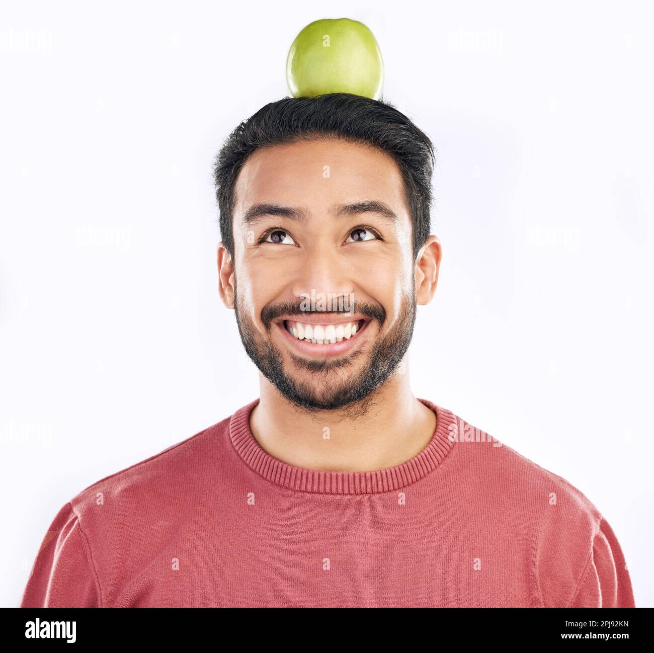Smile, apple and man in studio for diet, nutrition and balance with ...