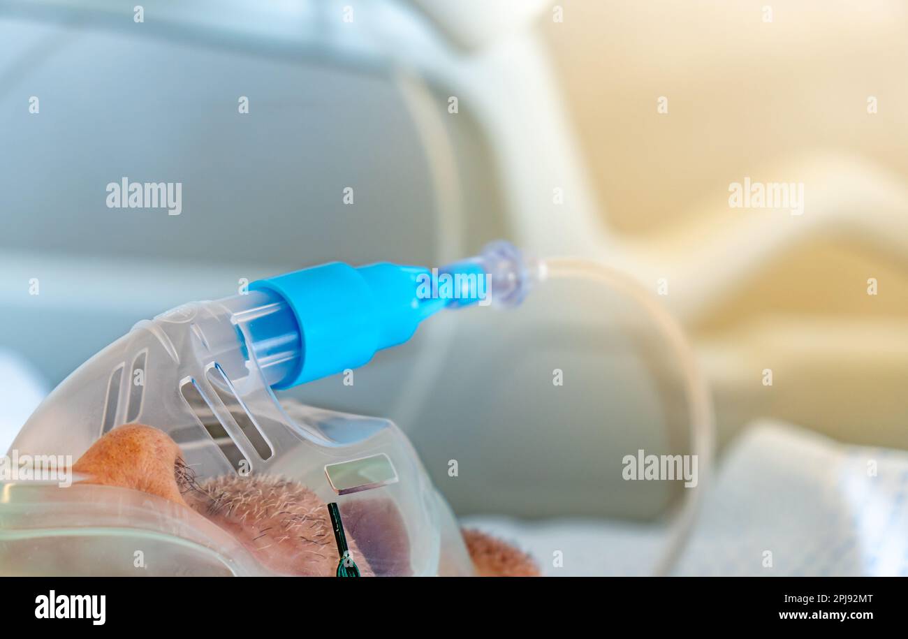 Profile view of the face of an elderly man in a hospital bed wearing a ...