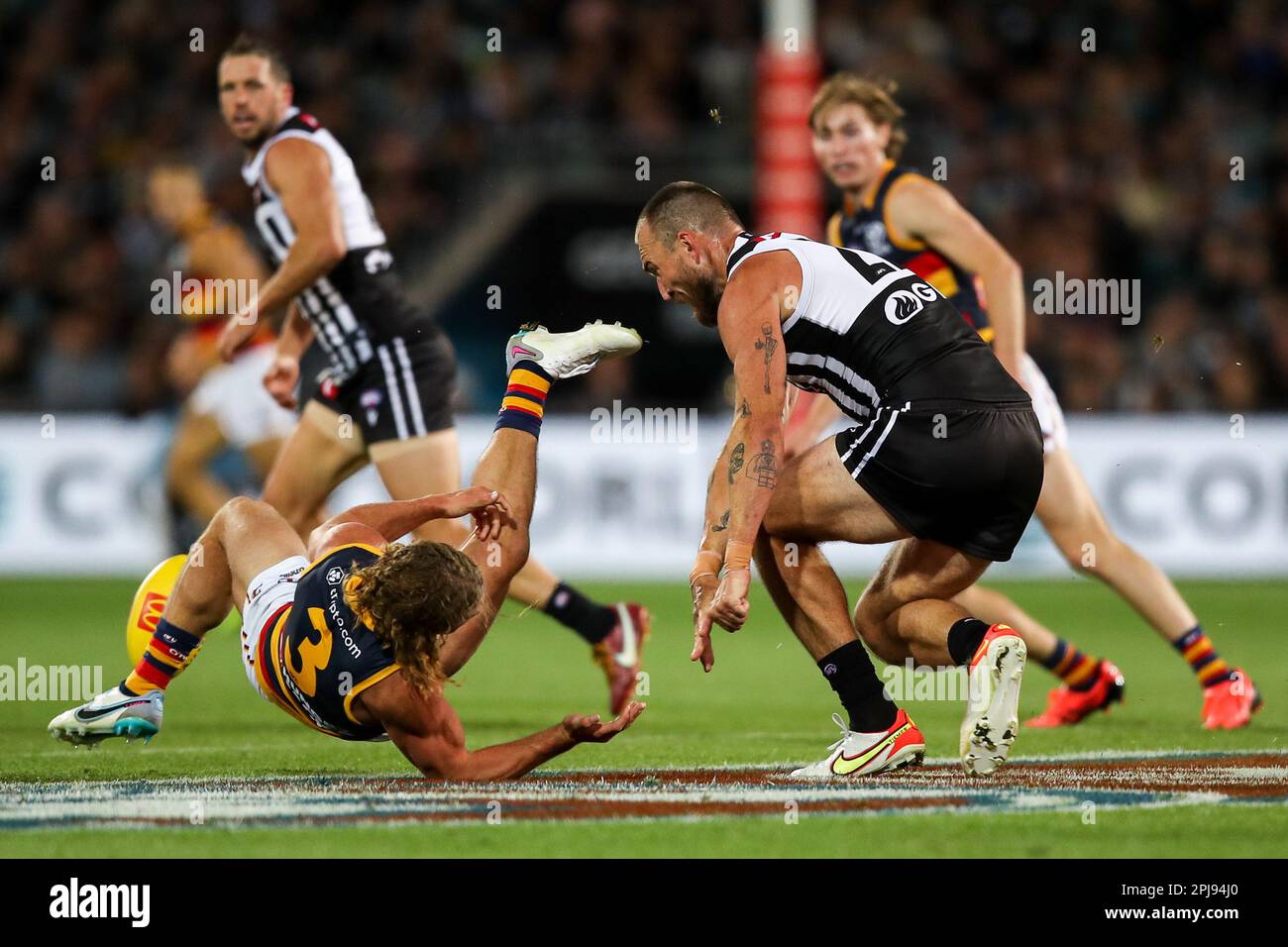 Charlie Dixon of the Power is tackled by Sam Berry of the Crows during ...
