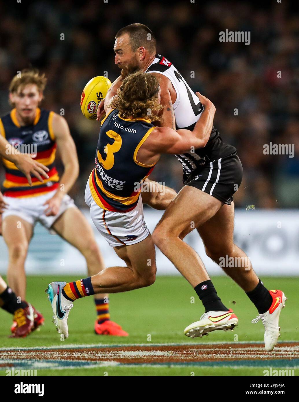 Charlie Dixon of the Power is tackled by Sam Berry of the Crows during ...