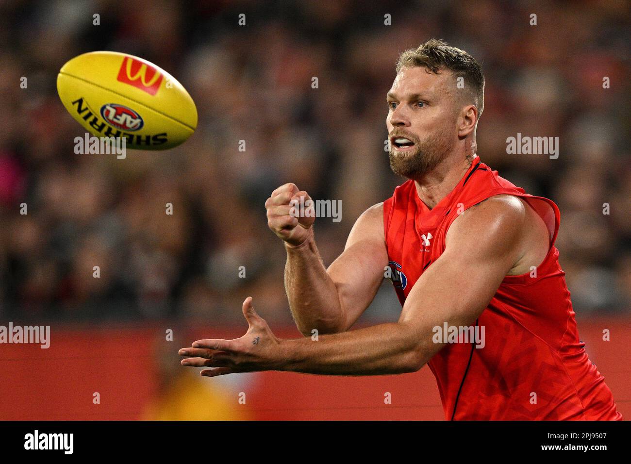 Jake Stringer of the Bombers handballs during the AFL Round 3 match ...