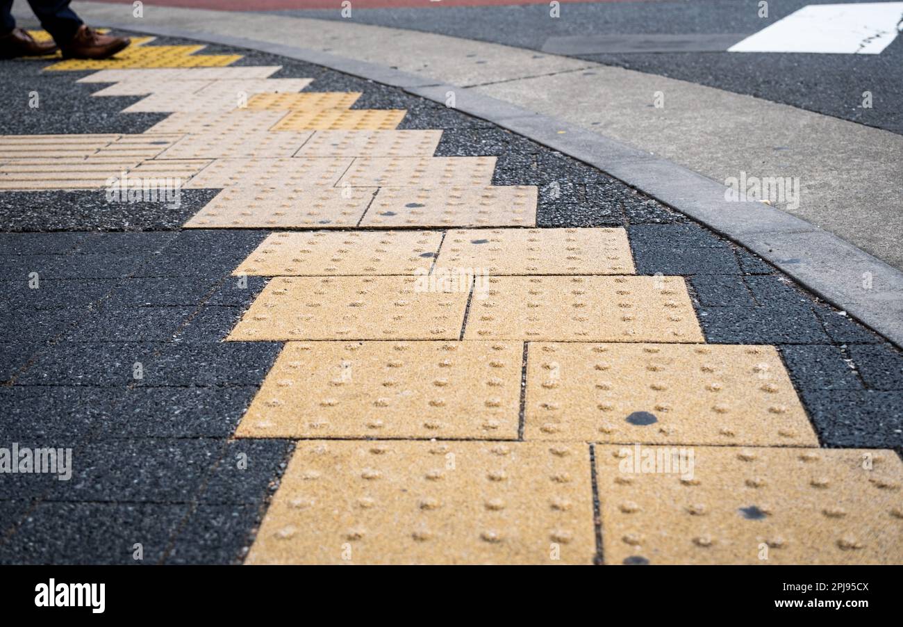 Japanese Yellow Tenji Blocks or tactile paving at a road crossing in ...