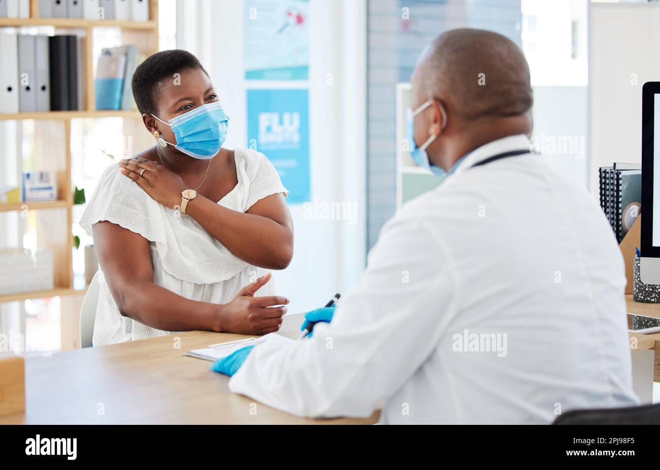 Doctor, covid and patient with shoulder pain in hospital, fibromyalgia ...