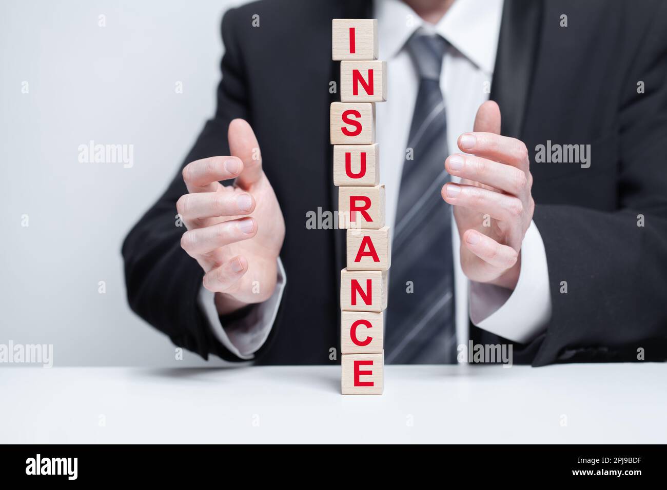 Wooden blocks with black word insurance, fragile pyramid, business ...