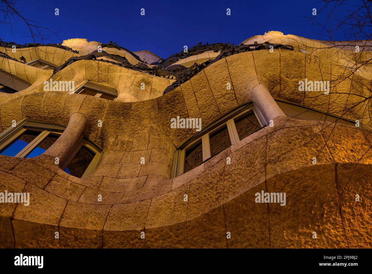 Facade of La Pedrera (Casa Milà) at twilight and night, a work of ...
