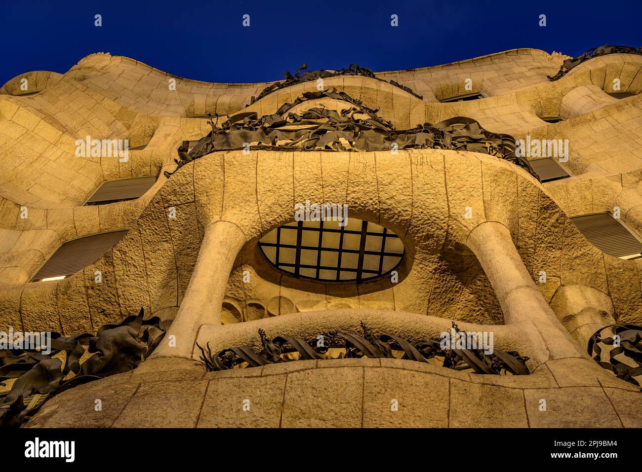 Facade of La Pedrera (Casa Milà) at twilight and night, a work of ...