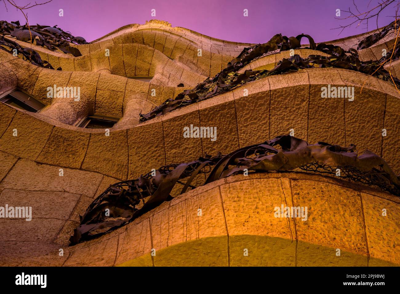 Facade of La Pedrera (Casa Milà) at twilight and night, a work of ...