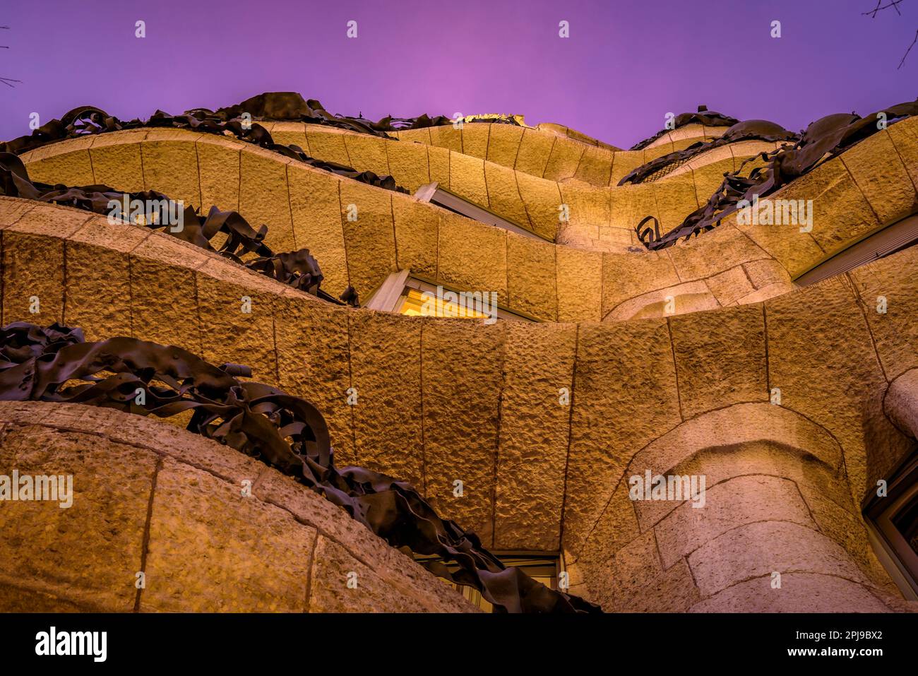Facade of La Pedrera (Casa Milà) at twilight and night, a work of ...