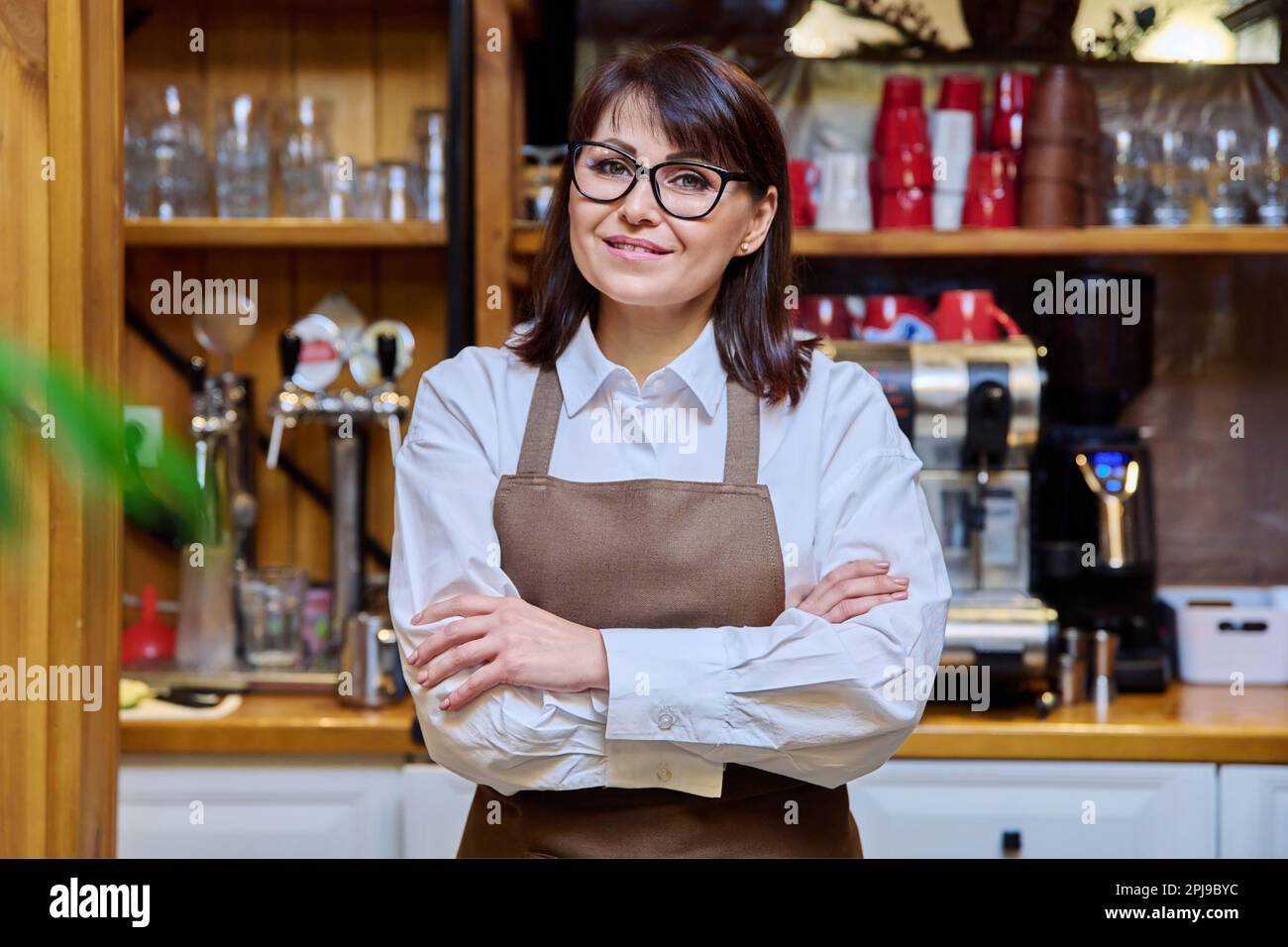 Portrait of middle aged confident woman restaurant owner Stock Photo ...