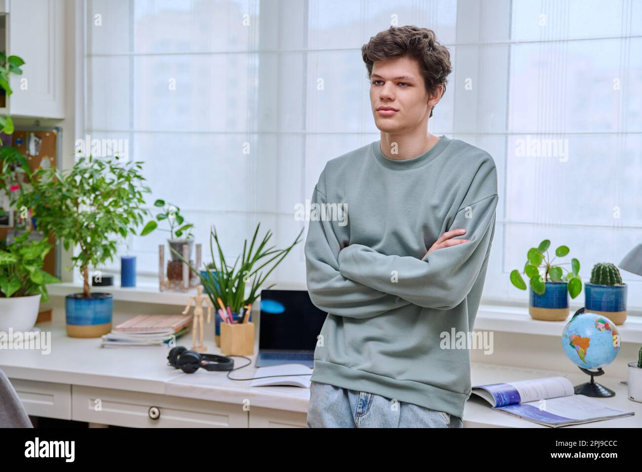 Portrait of handsome guy 19 years old in home interior Stock Photo - Alamy