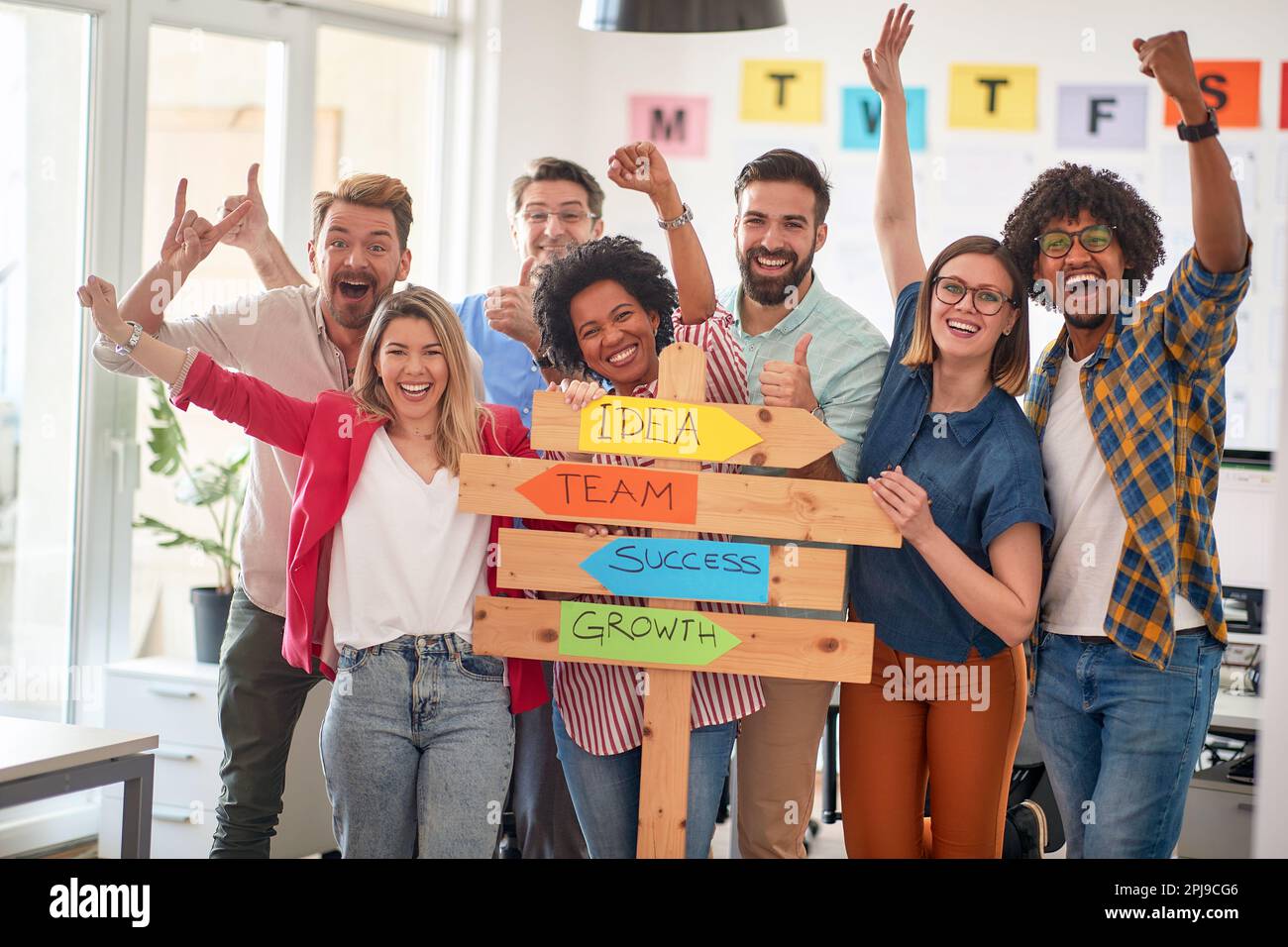 A group of happy office workers are enjoying while posing for a photo ...