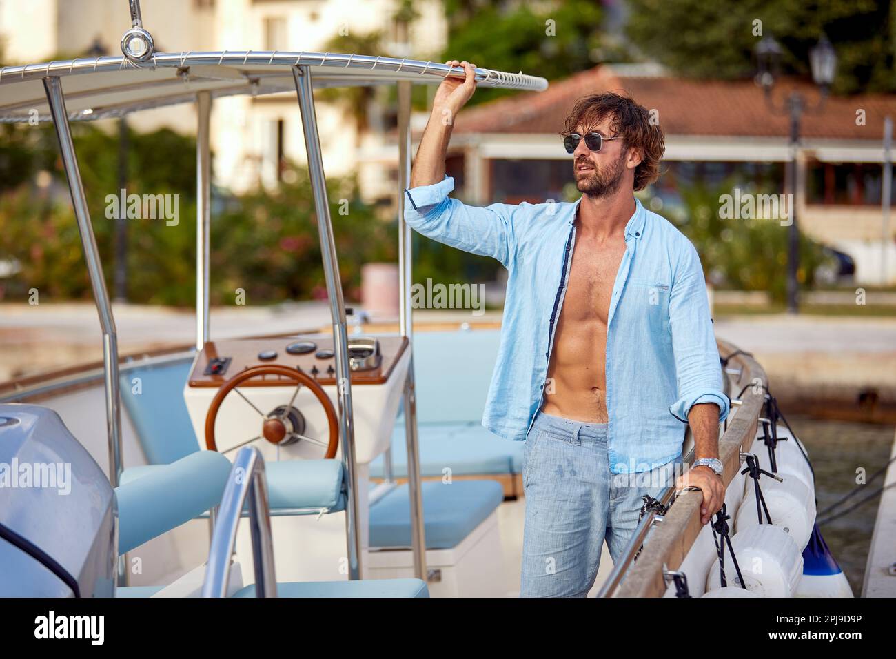 Happy man enjoys his boat on summer vacation Stock Photo - Alamy