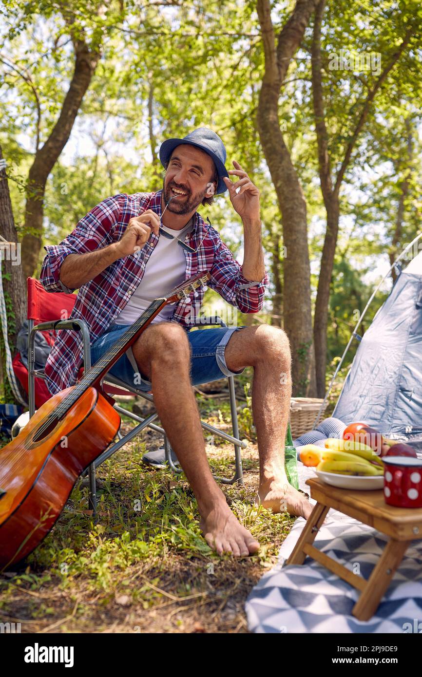 Young man green camping hi-res stock photography and images - Alamy
