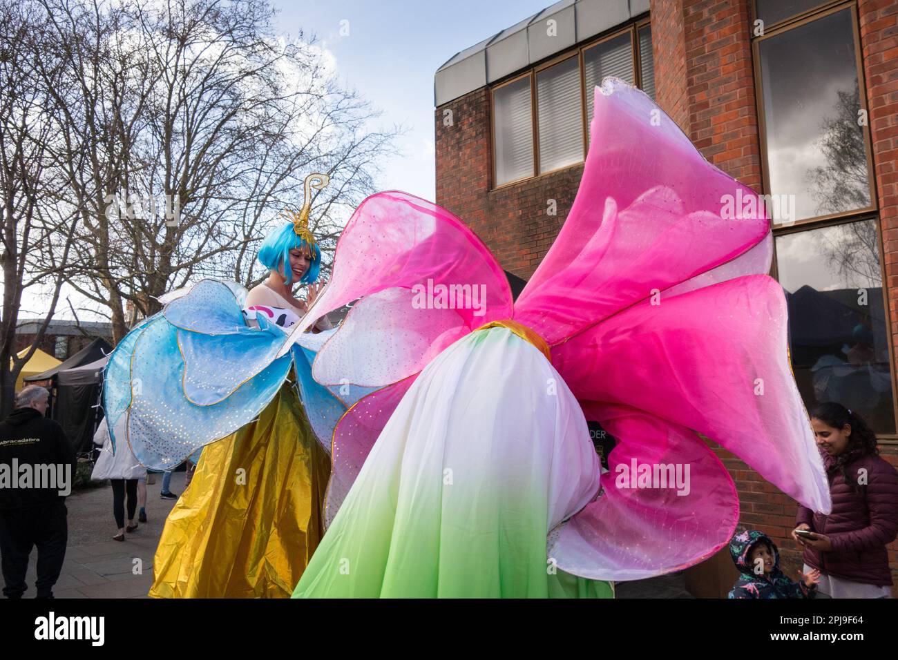 Two colourful young women on stilts at Sheen Library, Sheen, London ...