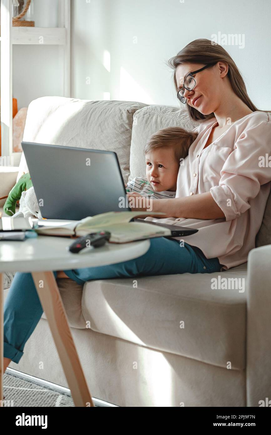 Concept work at home and home family education, mother working w Stock ...