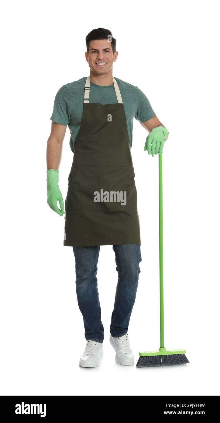 Man with green broom on white background Stock Photo - Alamy